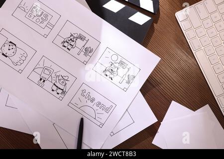 Storyboard with cartoon sketches at workplace, flat lay. Pre-production ...