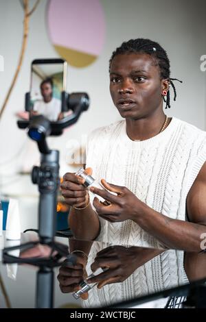 African american content creator filming technology review of different ...