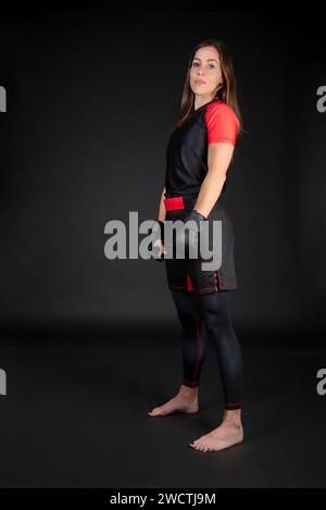 Caucasian MMA instructor with a cocky pose showing how strong she is ...