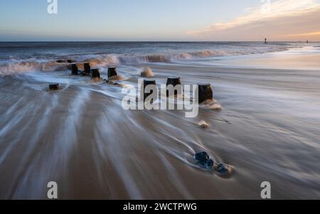 Soft sunrise swooshing seascape with old sea defences at Cart Gap ...