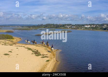 Portugal, Alentejo, Melides, riders along the Melides lagoon and its ...