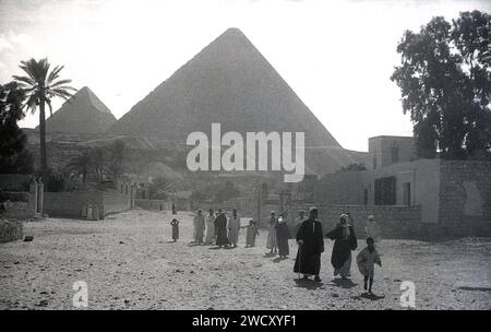 1950s, historical, Egypt, local people walking in a dusty area at Giza ...