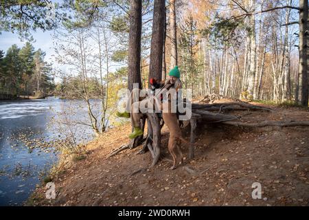 Cheerful woman nature lover sitting at marshland gathering wild ...