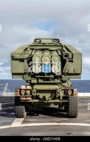 U.S. Marines position a HIMARS vehicle on the flight deck of a ship ...