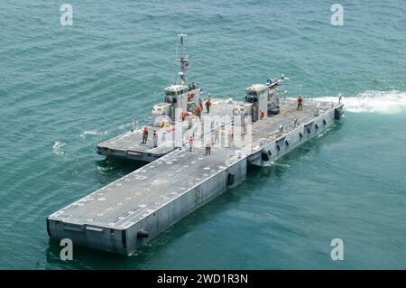 An Improved Navy Lighterage System (INLS) causeway ferry approaches the ...