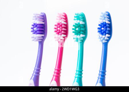 Four colourful plastic toothbrushes Stock Photo - Alamy