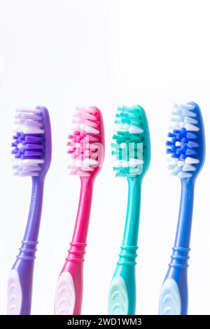 Four colourful plastic toothbrushes Stock Photo - Alamy