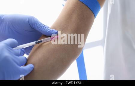 Nurse injects medication in womans vein with needle, blood test in ...