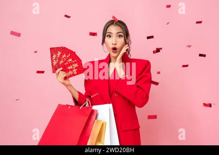 Shocked girl in festive red sweater pointing with finger isolated on ...