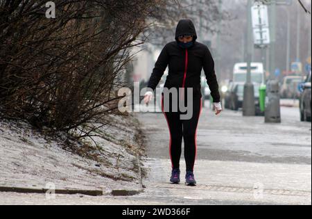 People walk carefully on the icy sidewalk in Prague, Czech Republic ...