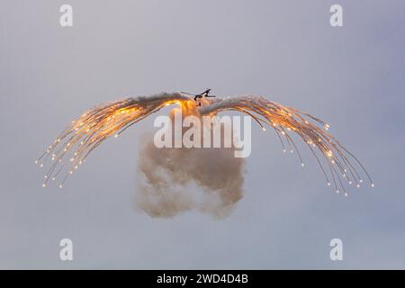 Helicopter deploying flares and chaff- (NH90 military helicopter) a ...