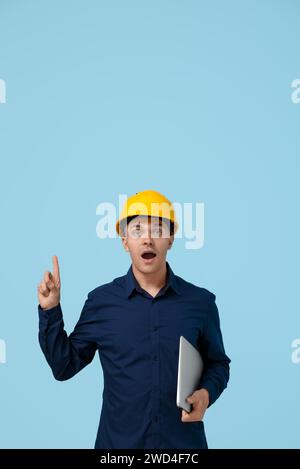 Portrait of surprised engineer man pointing side. Amazed engineer ...