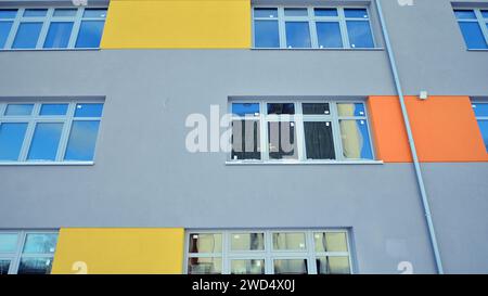Multi-colored facades of the school with white window frames Stock ...