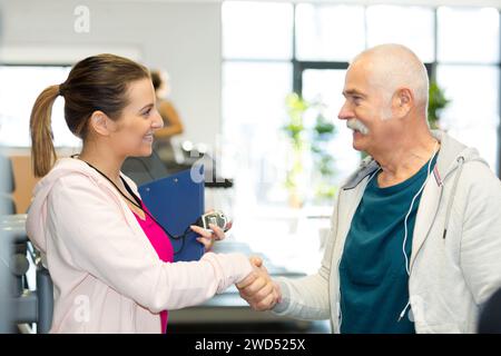 sports coach guiding senior man Stock Photo - Alamy