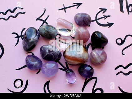 Beautiful amethyst and rose quartz crystals on a pink background with ...