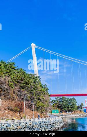 Pylons of suspension bridge on highway under blue sky, South Korea ...