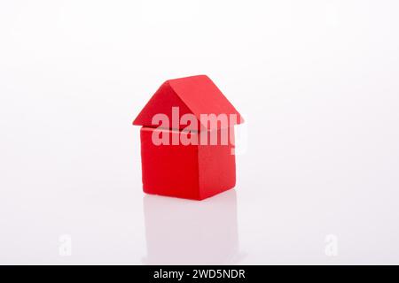 House made of red color blocks on a white background Stock Photo - Alamy