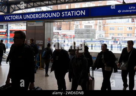 A busy entrance and exit to Victoria Underground Station with the ...