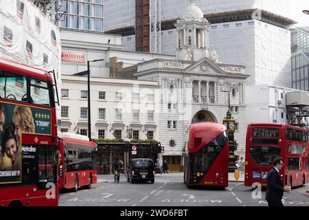 Buses of different shapes and sizes leaving Victoria Station with Victoria Palace Theatre in the ...
