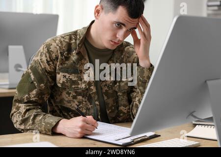 Military service. Young soldier working in office Stock Photo - Alamy