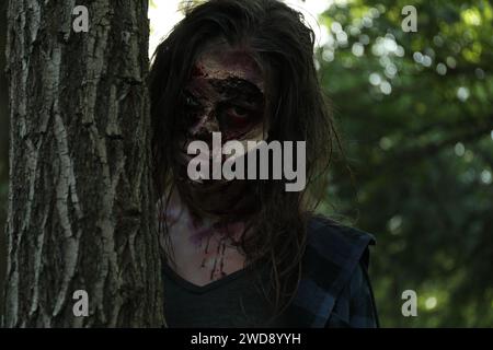 Scary zombie near tree outdoors. Halloween monster Stock Photo - Alamy