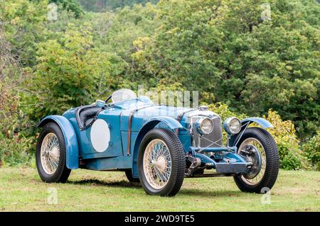 1934 Riley Ulster Imp driving on a French country road Stock Photo - Alamy