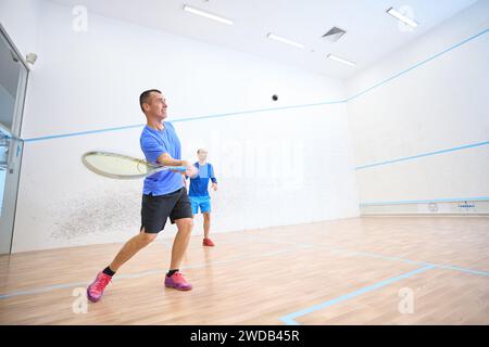 Active men working out engaging in friendly squash matches Stock Photo ...