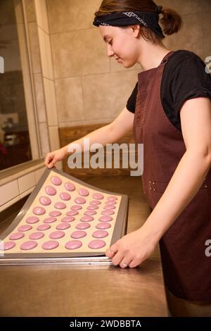 Young female chef on pink background Stock Photo - Alamy