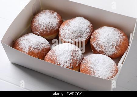 Delicious sweet buns in box on gray table, top view. Space for text ...