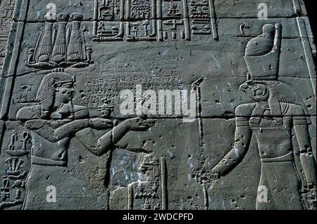 Relief of Horus, depicted with a head of a falcon, and gwife Hathor ...