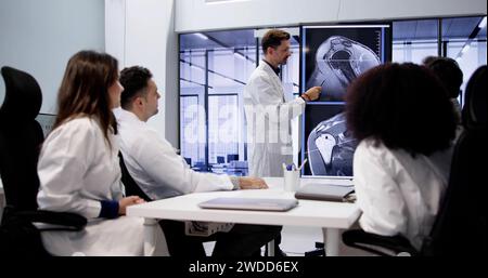 Diverse Doctors Team Looking At Shoulder MRT Scans Stock Photo - Alamy