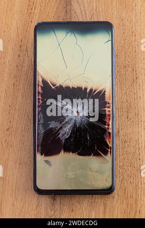 Smartphone destroyed by exploded lithium battery isolated on white ...