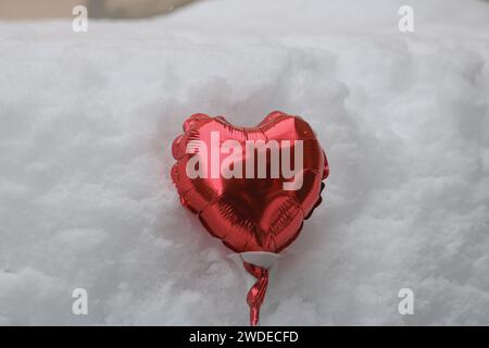 Red balloon in the snow Stock Photo - Alamy