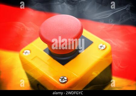 Roter Alarmknopf auf einer Deutschlandfahne *** Red alarm button on a ...