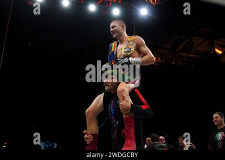 Zak Chelli is lifted up by a member of his team after victory against ...