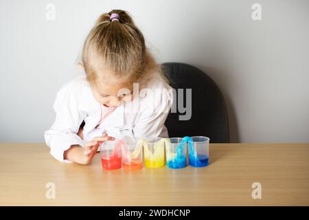 Little girl doing science experiment. Kindergarten. Education concept ...