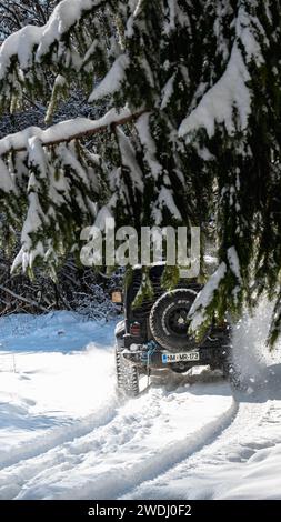 A Jeep wrangler covered in snow at sunset on a cold winter day Stock ...