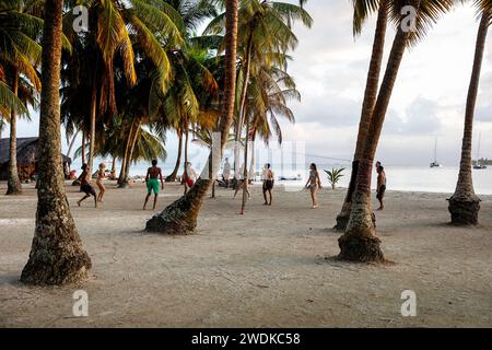 Tourists playing on volley ball court next to the beach road in Roda ...