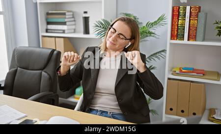 A workaholic Caucasian blonde female executive reading emails on a ...