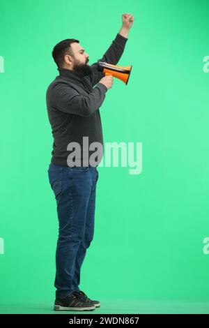 Full length photo of attractive man in striped t-shirt smiling and ...