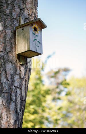 Wooden bird feeder in the form of a house with bait Stock Photo - Alamy