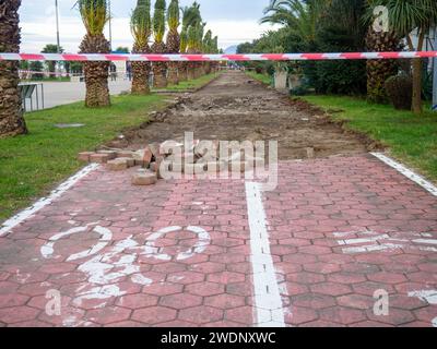 Reconstruction of the bike path. Replacing tiles on a bike path among ...