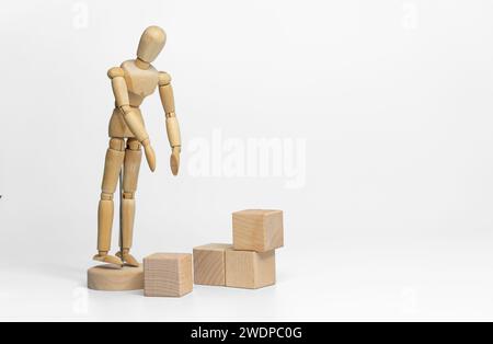 Wooden doll with wooden toy block isolated on white background ...