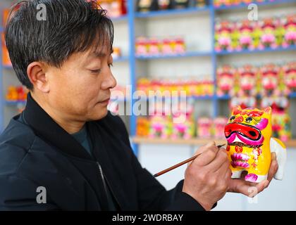 Gaomi, China. 22nd Jan, 2024. A villager, Nie Laichen, is painting ...