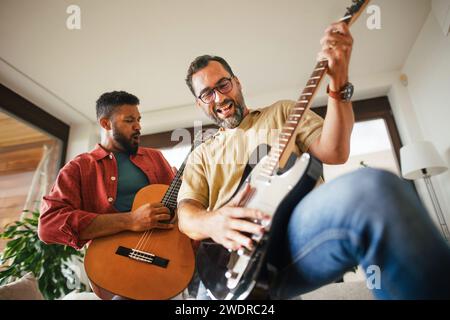Best friends, musician jamming together. Playing music on guitar ...
