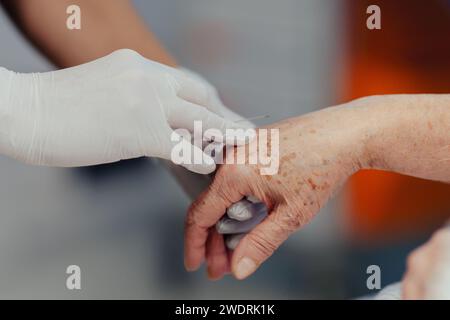 Close up of nurse insering IV cannula in little girl hand. IV ...