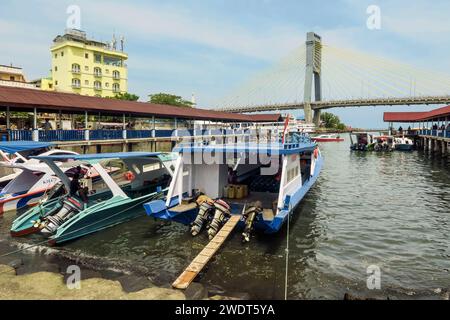Boats in Manado port and Soekarno Bridge in provincial capital of ...