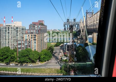 Roosevelt Island Tramway, aerial view of a tram car passing East 60th ...