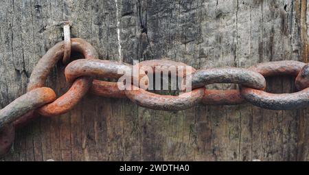 Detail of an old rusty metal chain anchored to a concrete block Stock ...