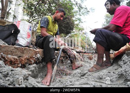 Technician repairing an underground telephone line multi colored wires ...